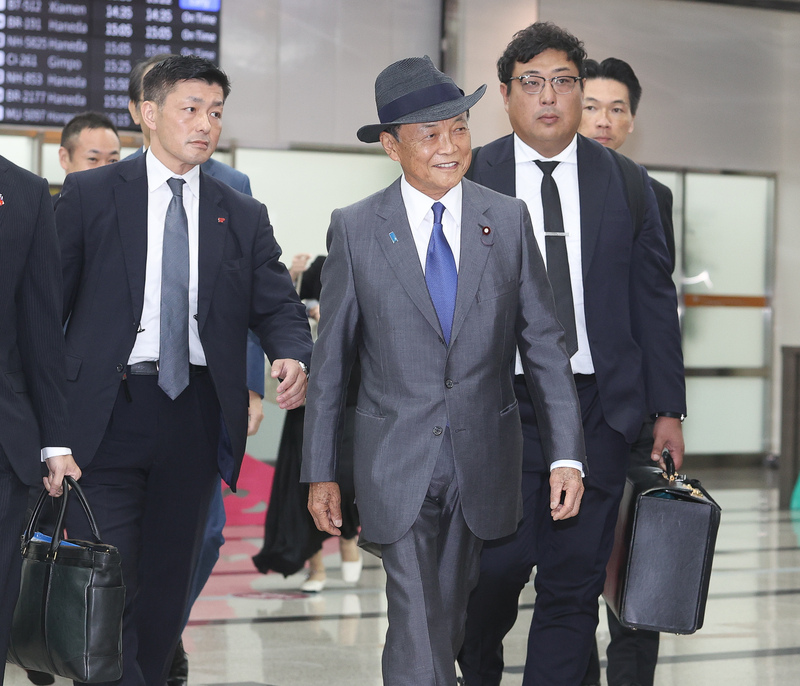 Japan’s former Prime Minister Taro Aso arrives in Taiwan to give a ...
